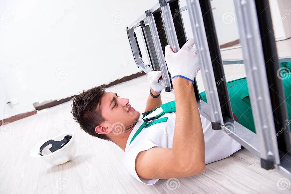 The Young Worker Falling from the Ladder Stock Image - Image of ladder ...