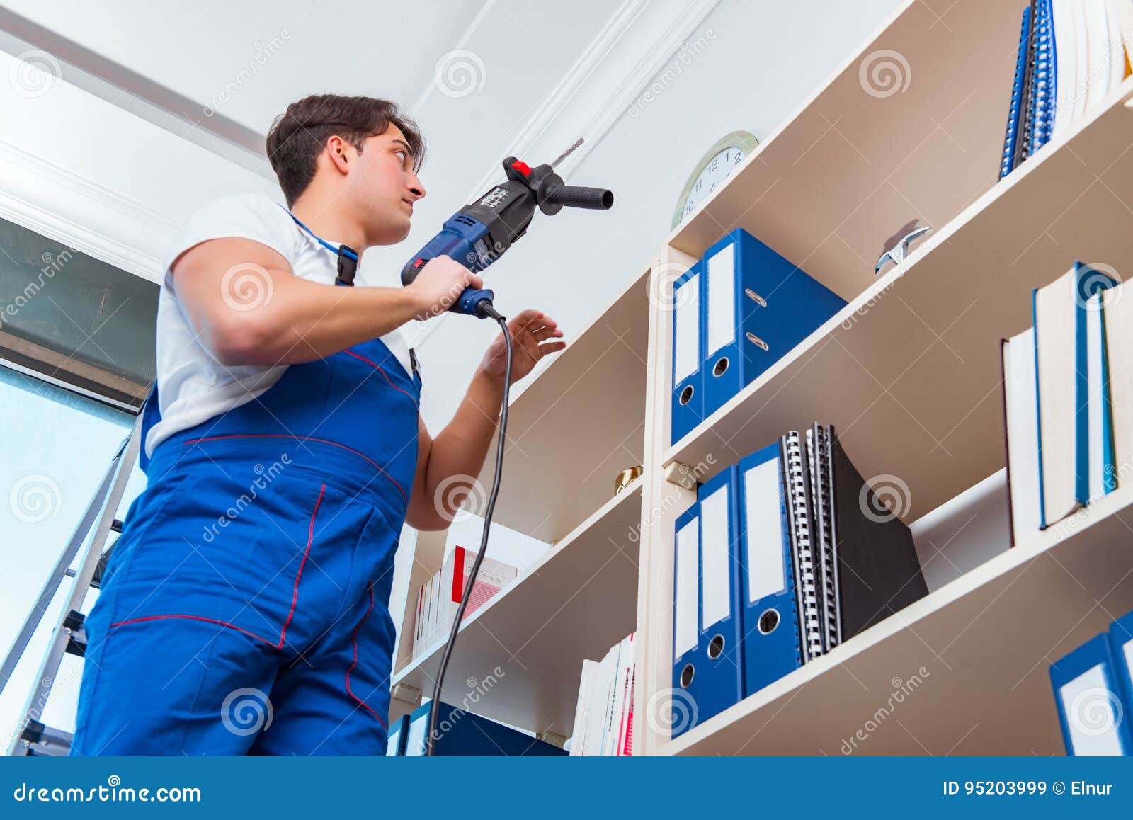 The Young Worker Repairing Shelves in Office Stock Image - Image of ...