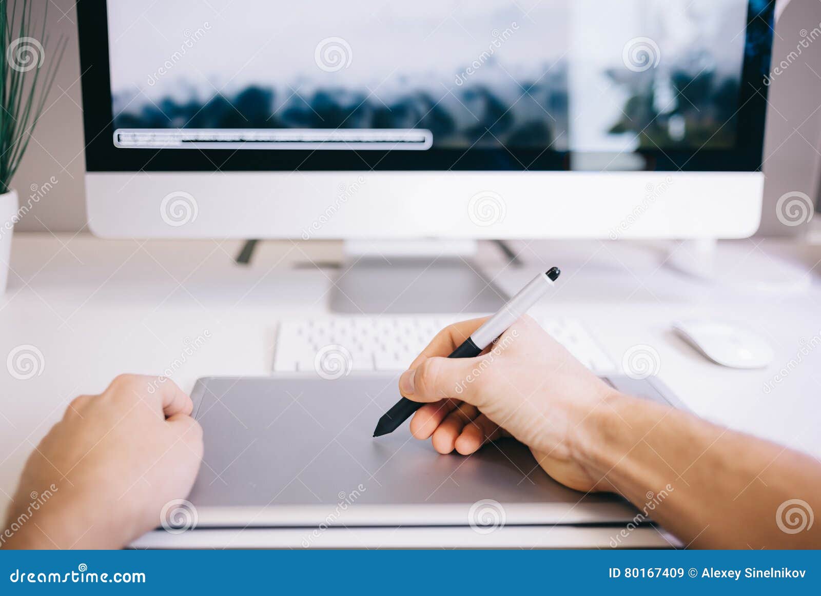 Young Worker Sitting in an Office at the Computer. Freelancer in a Blue ...