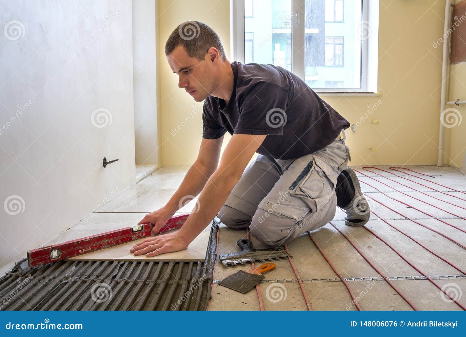 Tiler Installing Large Format Tile On Wall. Tile Leveling System Stock ...