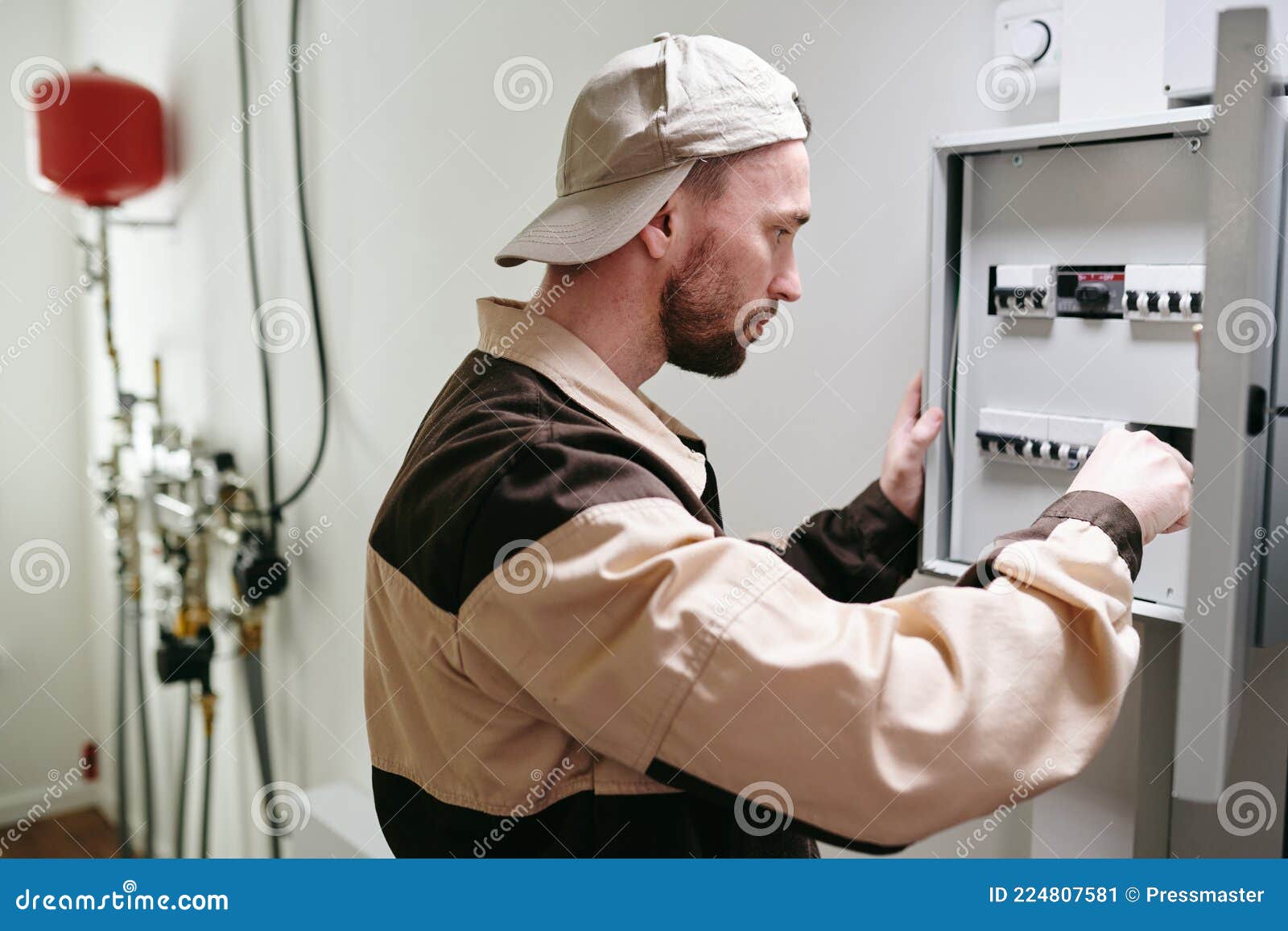 Young Worker in Uniform Adjusting Dashboard Stock Image - Image of ...