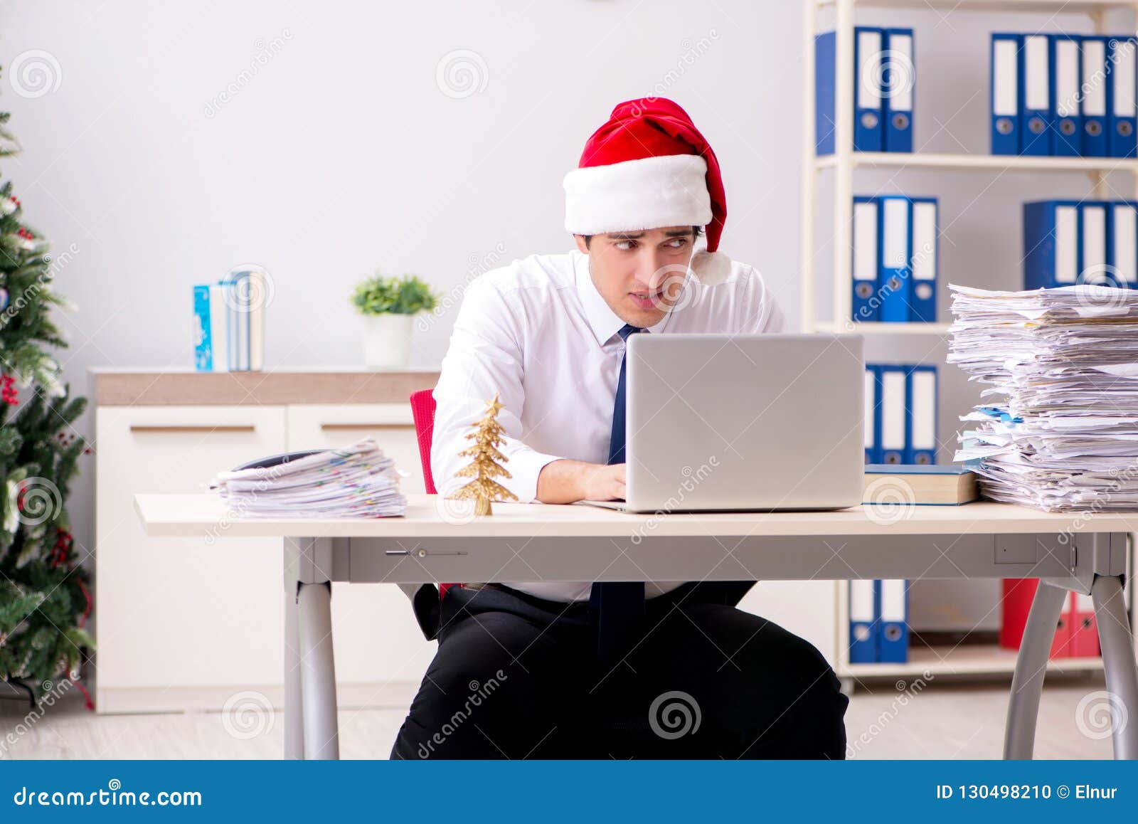 The Young Worker Working in Office on Christmas Shift Stock Photo ...
