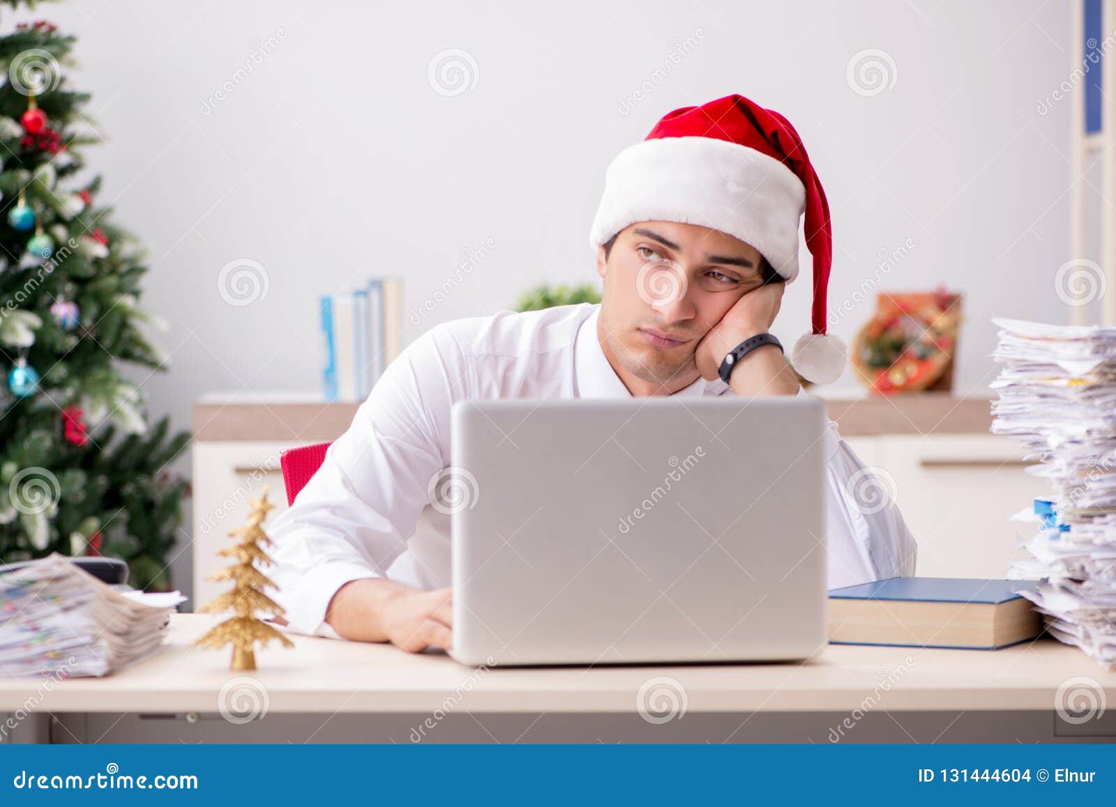 The Young Worker Working in Office on Christmas Shift Stock Photo ...