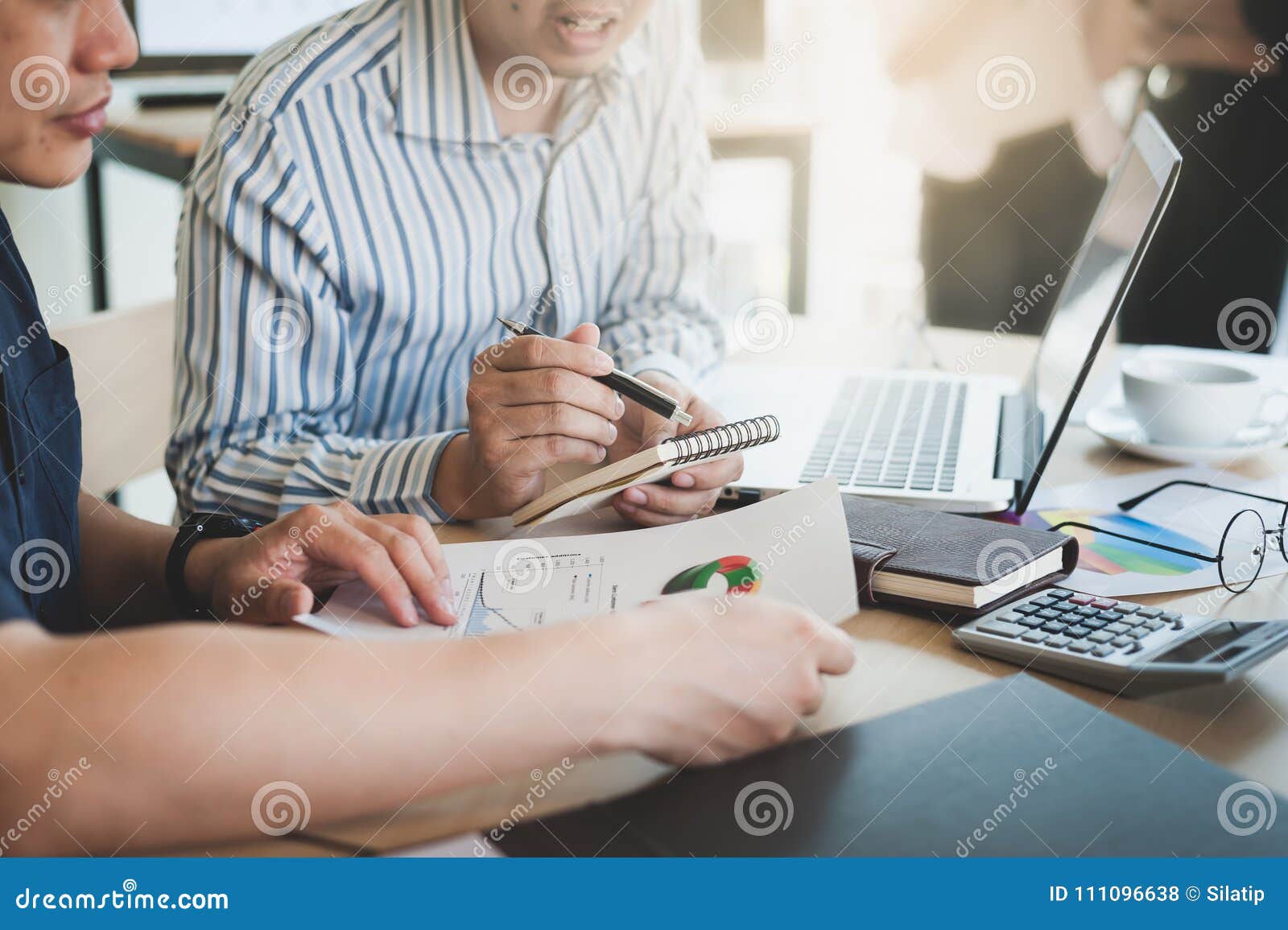 Young Worker Writing on Notebbok while Working with Colleague Stock ...