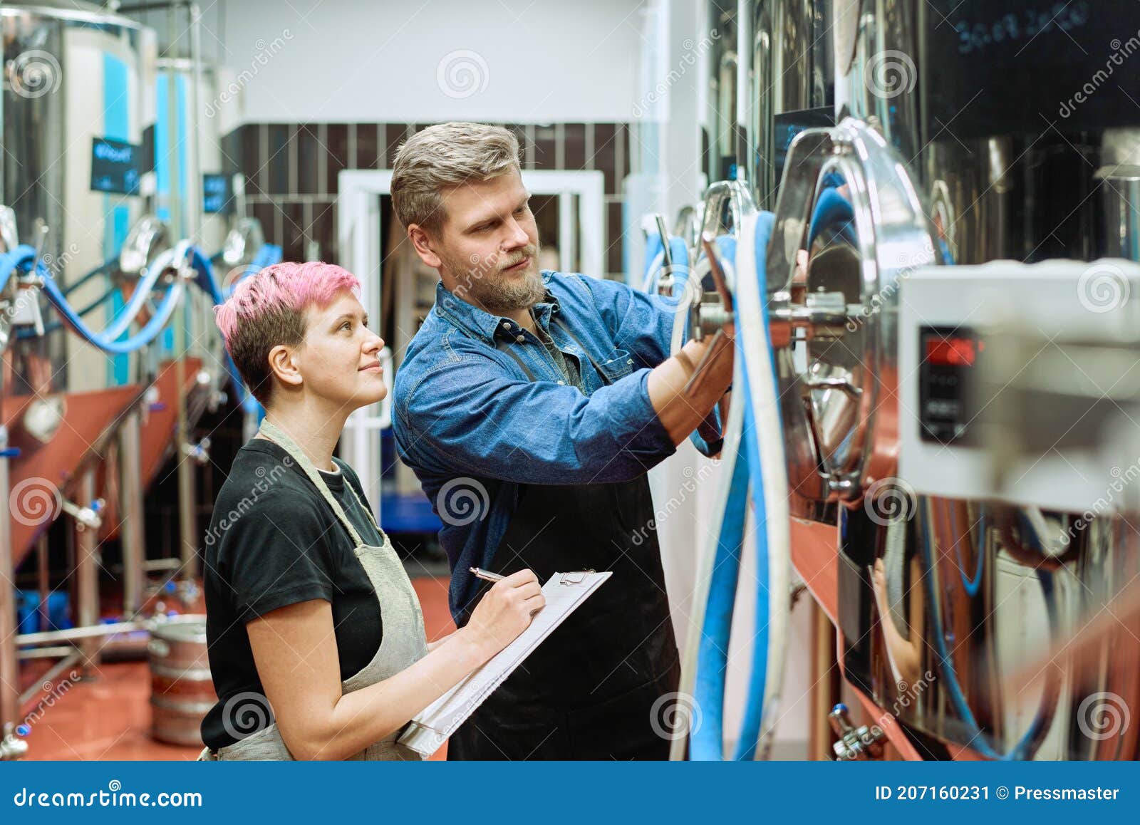 Young Workers of Beer Production Factory Standing by Large Processing ...