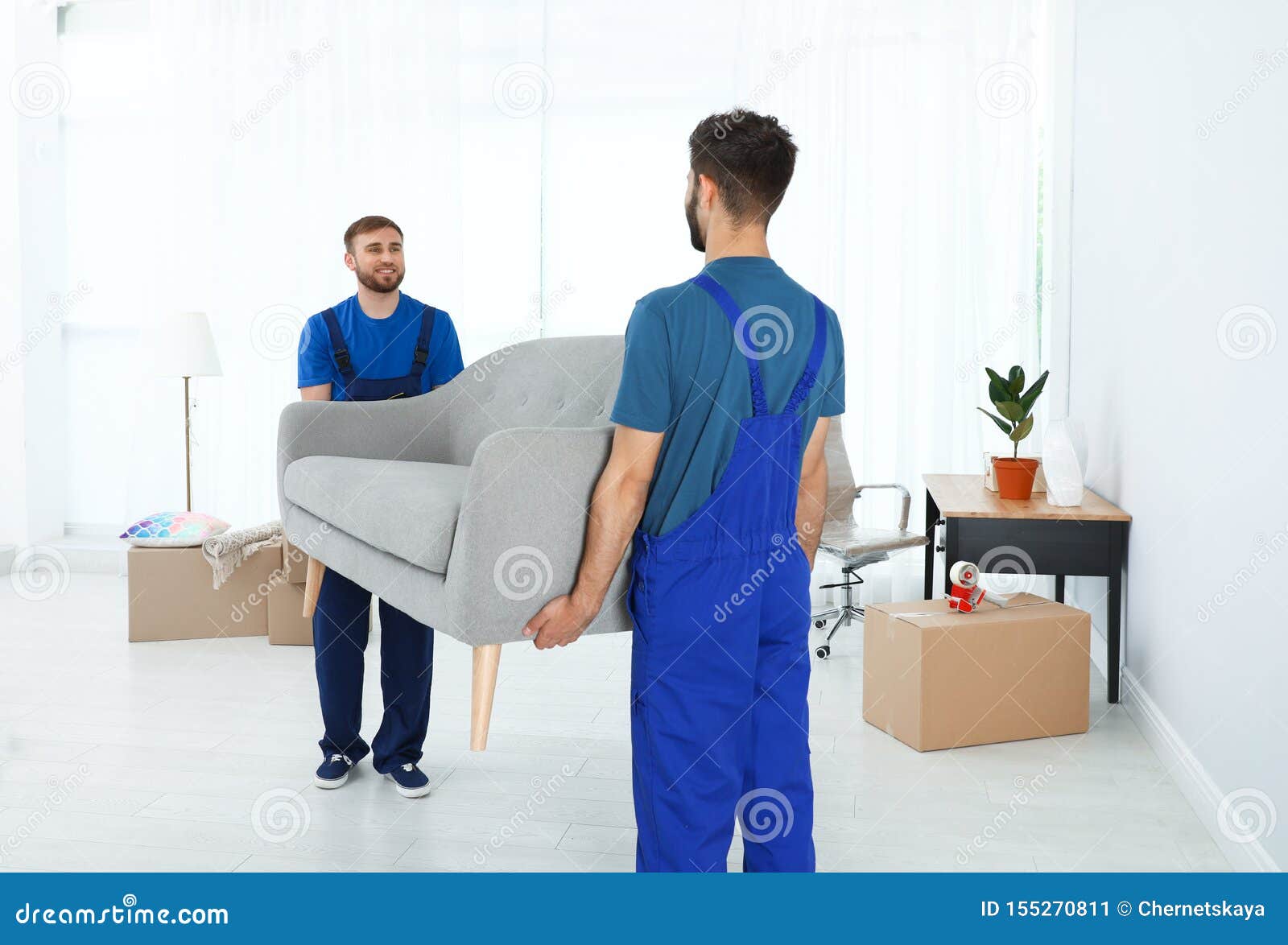 Young Workers Carrying Sofa in Room Stock Image - Image of heavy ...