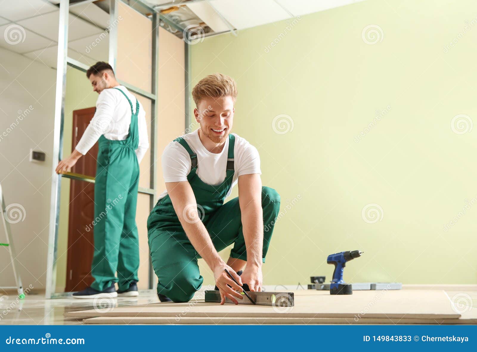 Young Workers Installing Drywall. Home Repair Service Stock Image ...