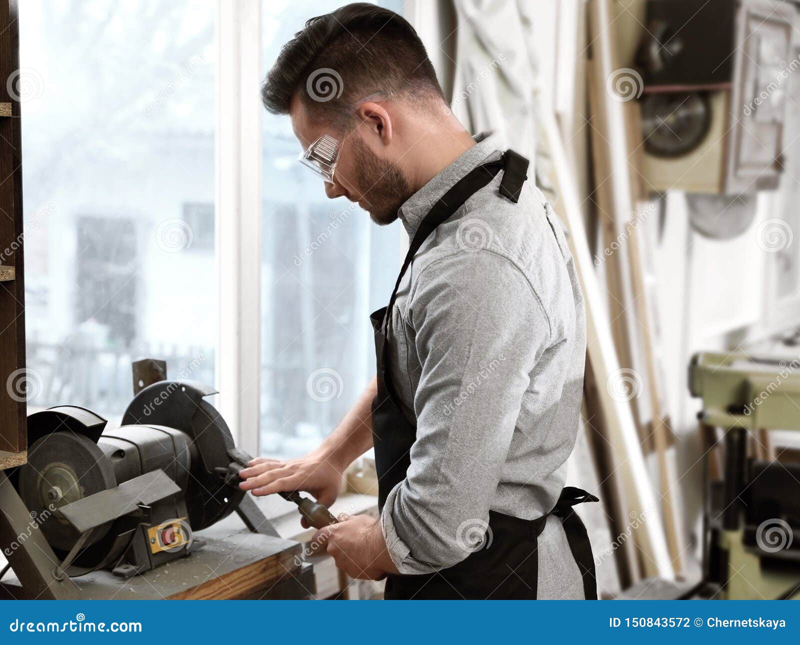 Young Working Man Using Grinding Machine Stock Photo - Image of ...