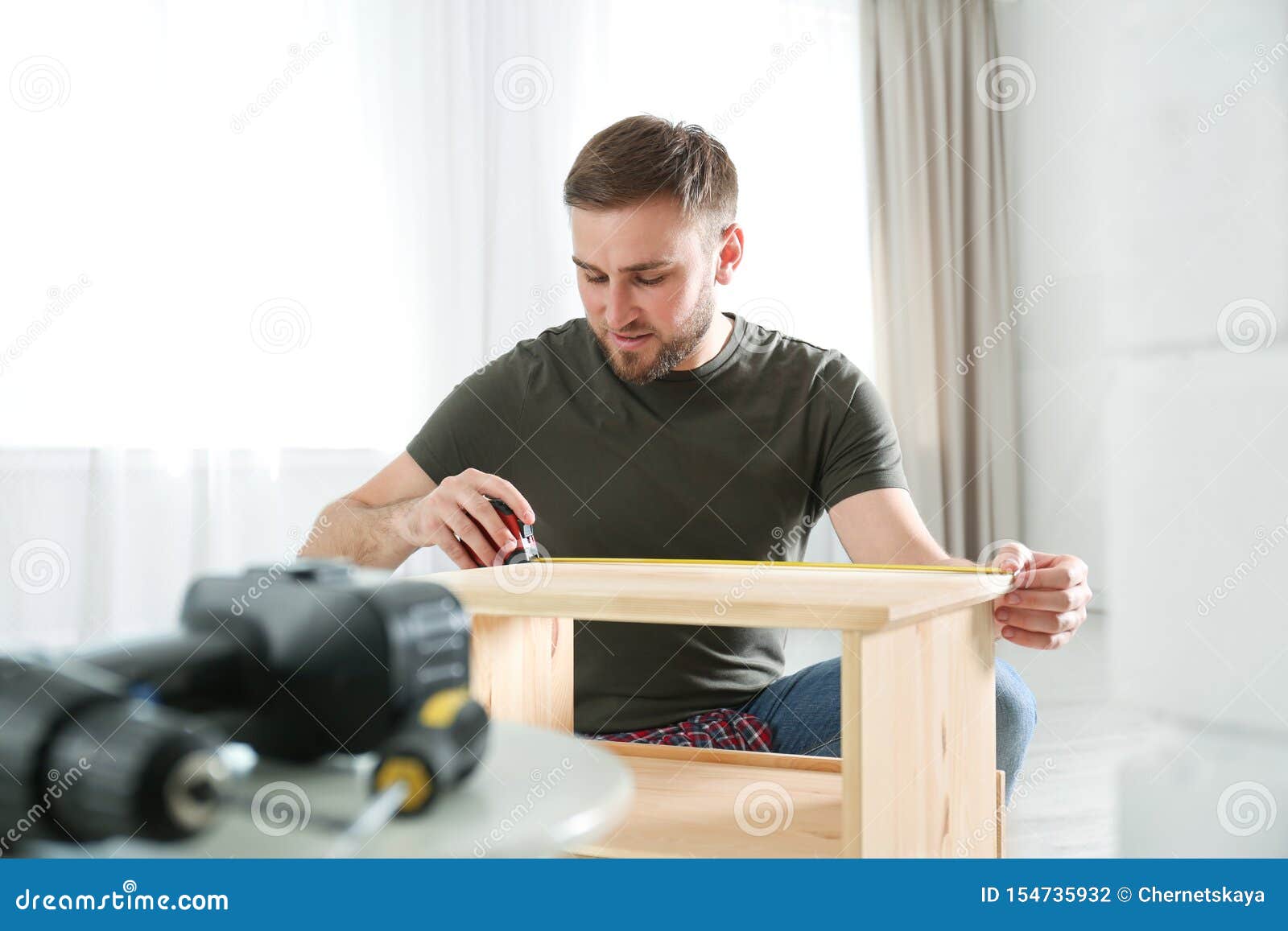 Young Working Man Using Measure Tape at Stock Photo - Image of ...