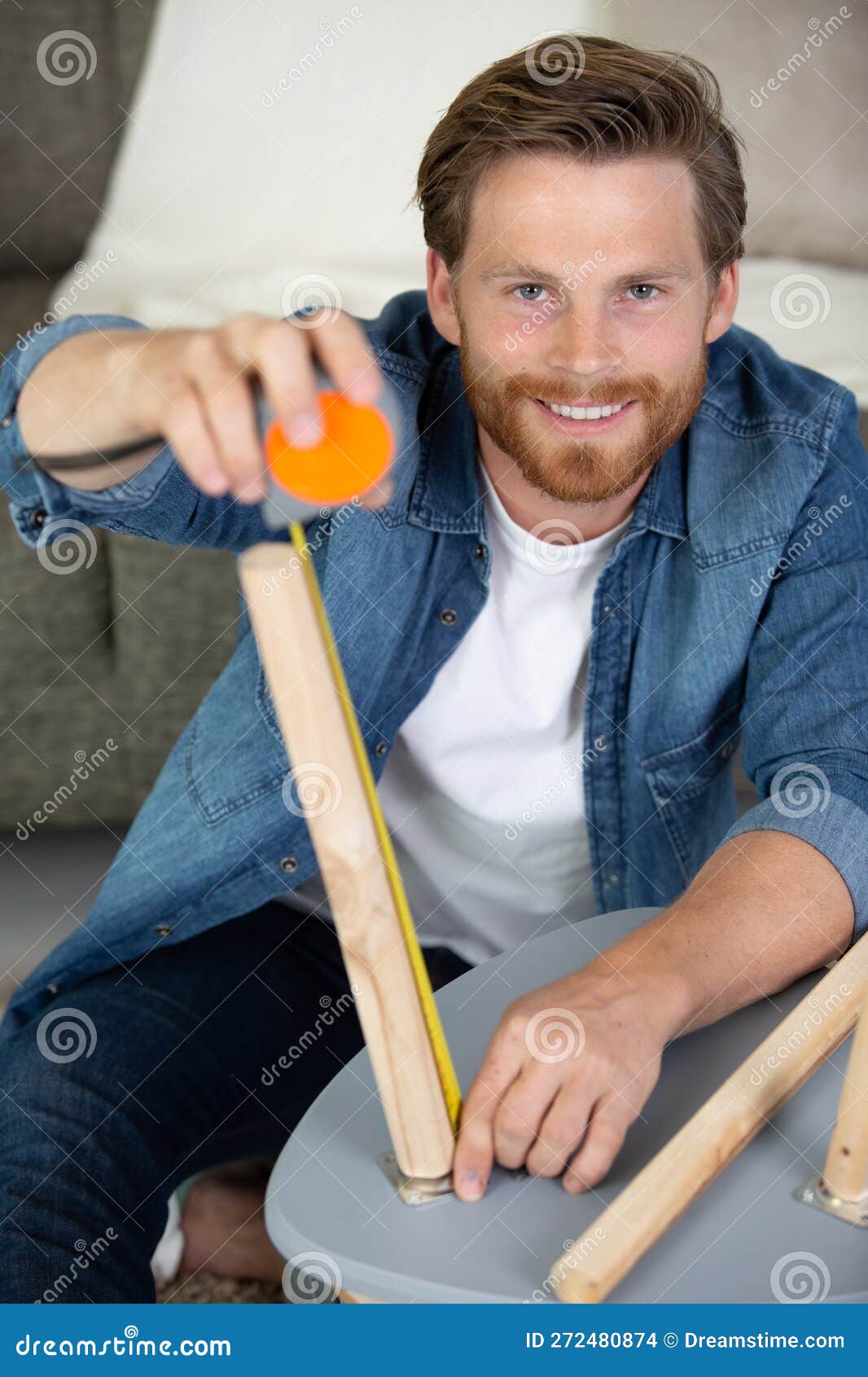 Young Working Man Using Measure Tape at Home Stock Photo - Image of ...