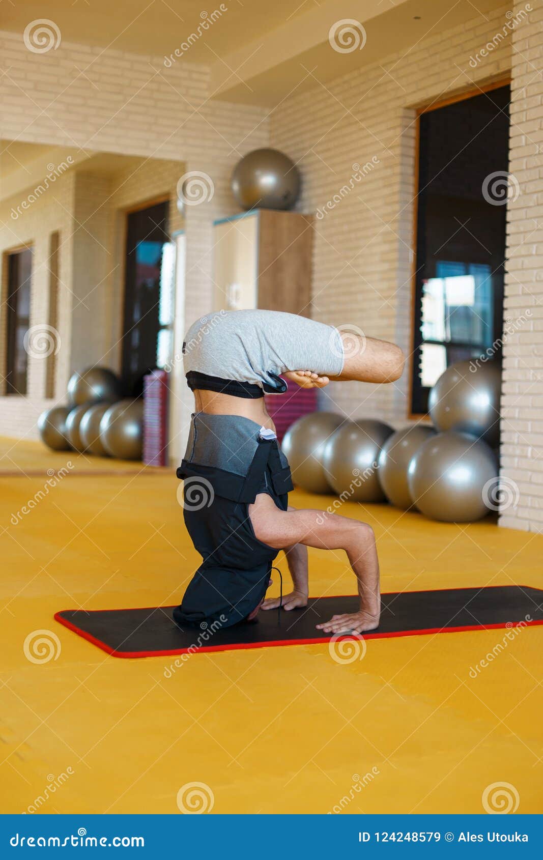 Young Yoga Man in Hood Doing Poses in Yellow Studio Stock Image - Image ...