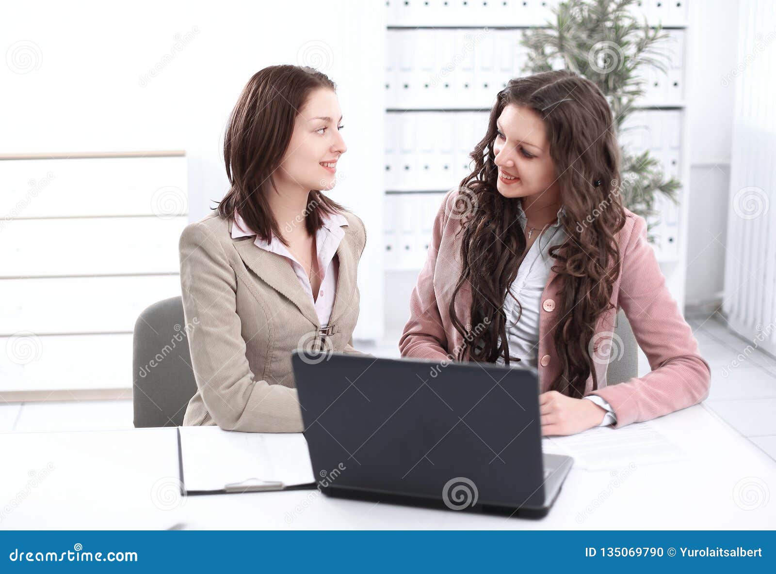 Younger Employees Discussing Work Issues,sitting Behind a Desk . Stock ...