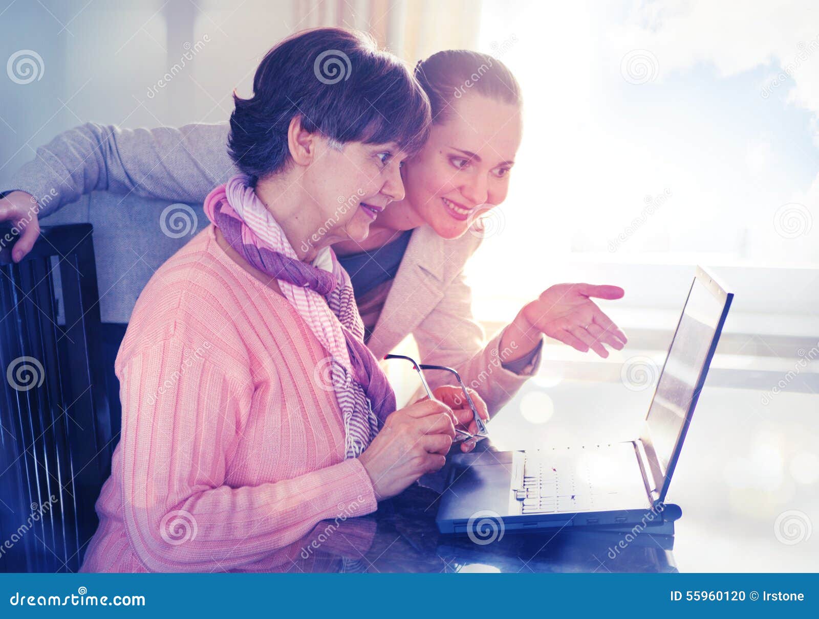 Younger Woman Helping an Elderly Person Using Laptop Computer for ...