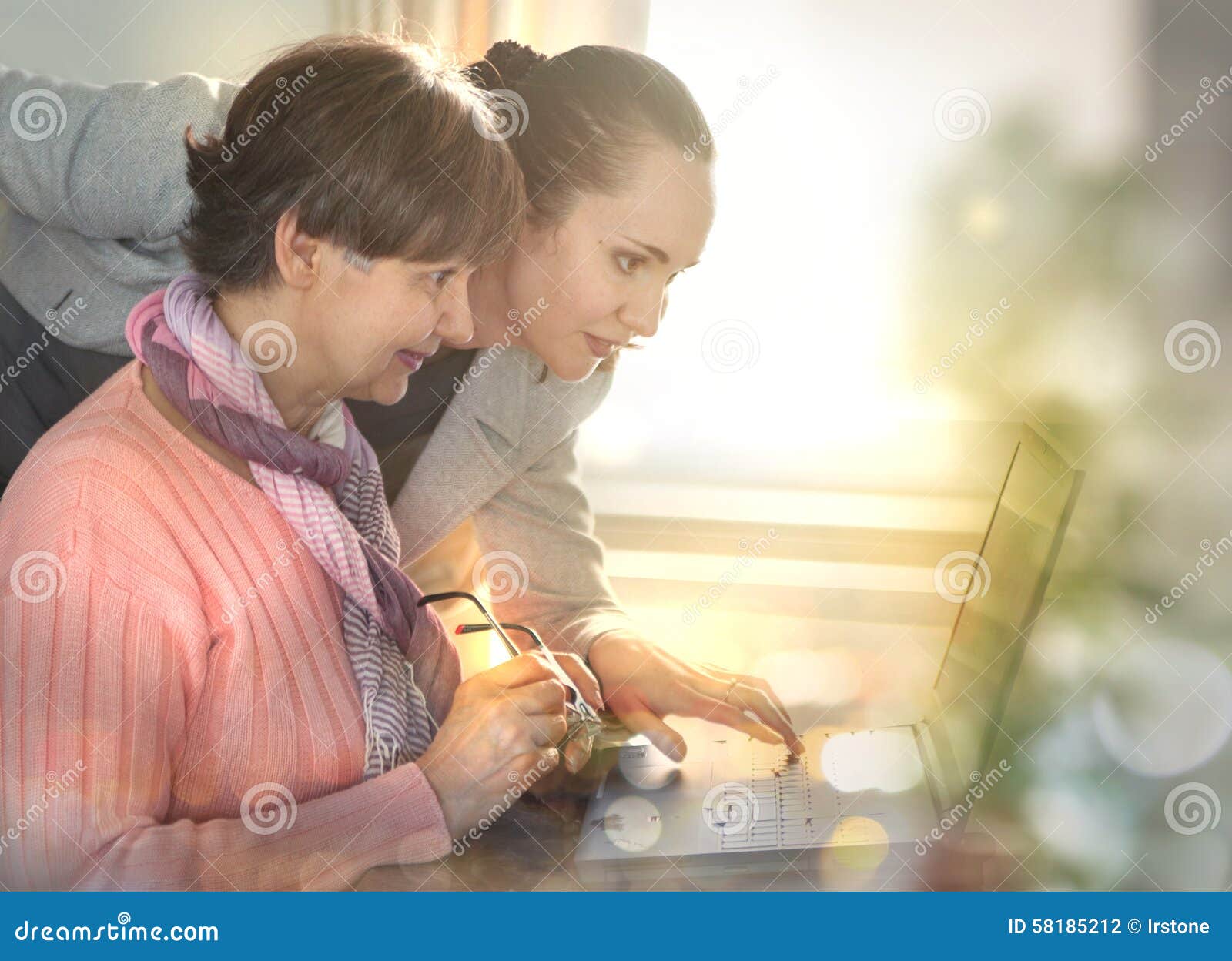 Younger Woman Helping an Elderly Person Using Laptop Computer for ...