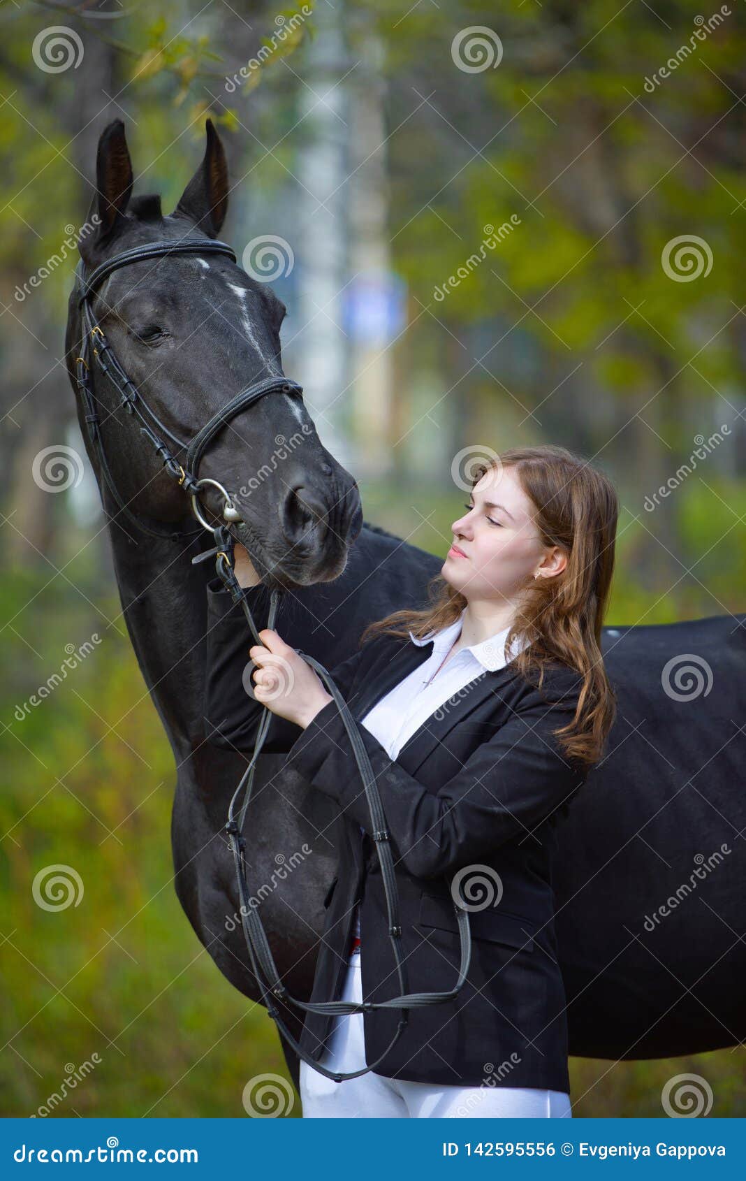 Young Girl Rider with a Black Horse in the Spring Stock Photo - Image ...