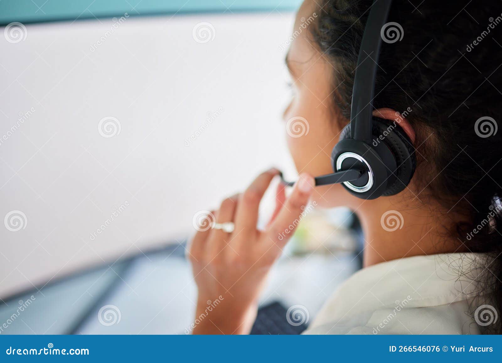 At Your Service. an Unrecognisable Call Centre Agent Sitting Alone in ...
