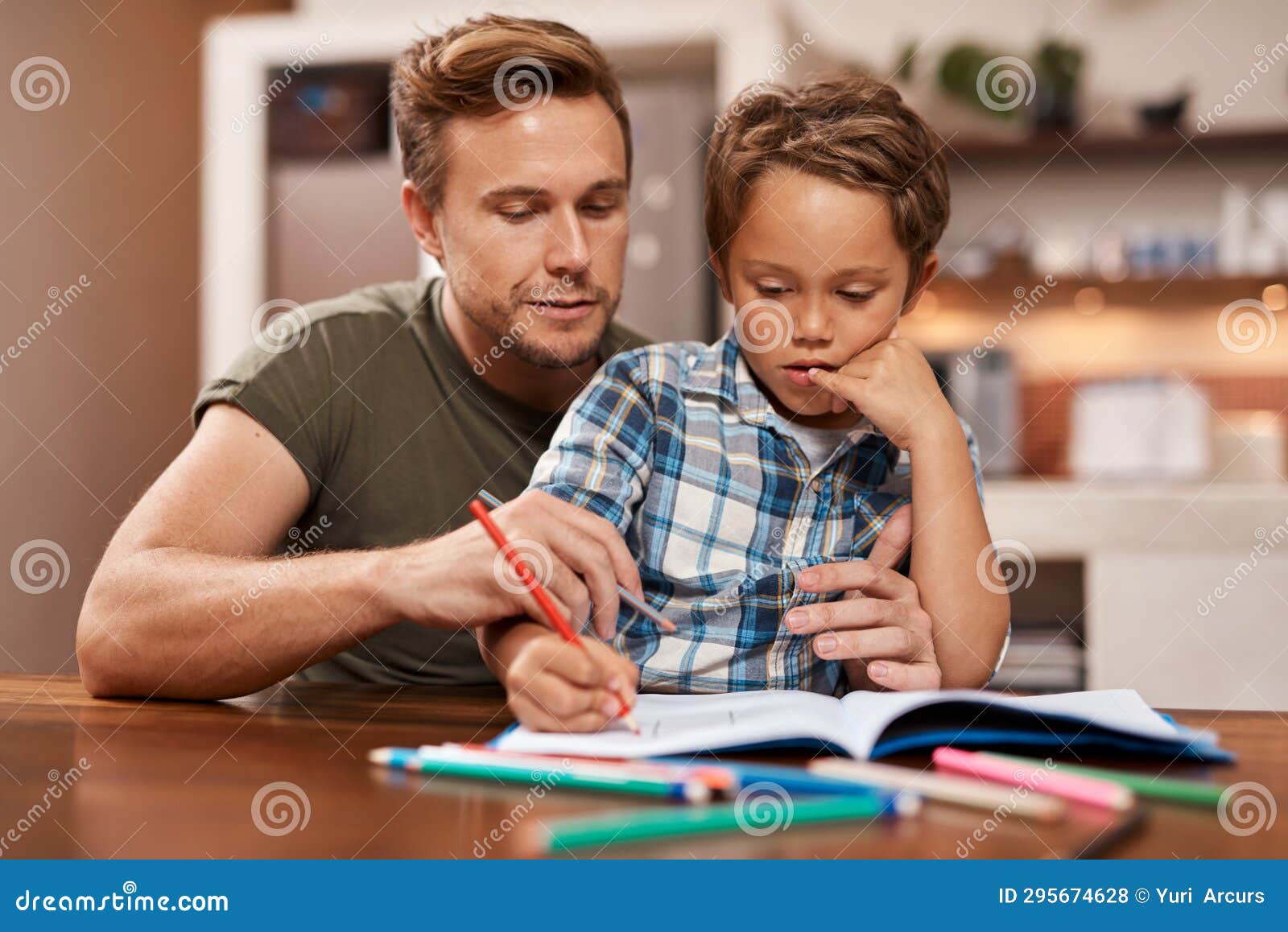 Youre Doing Well, Buddy. a Man Sitting with His Son while he Does His ...