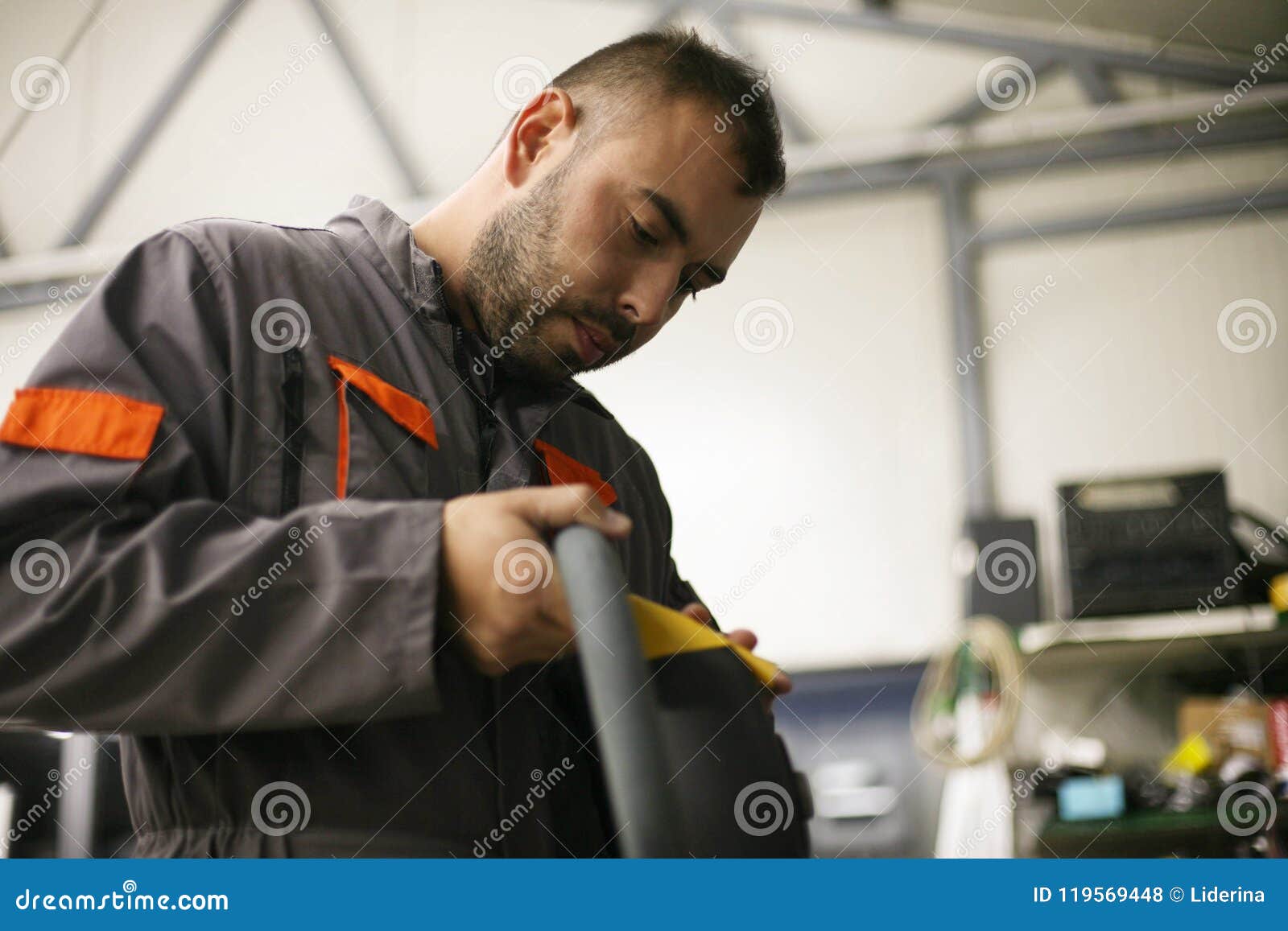 Young worker in workshop. stock photo. Image of white - 119569448