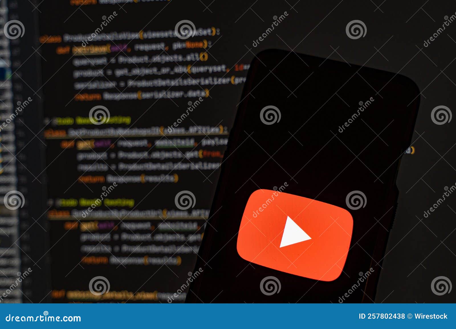 Youtube App on a Phone in Front of a Screen with Code on it Editorial ...