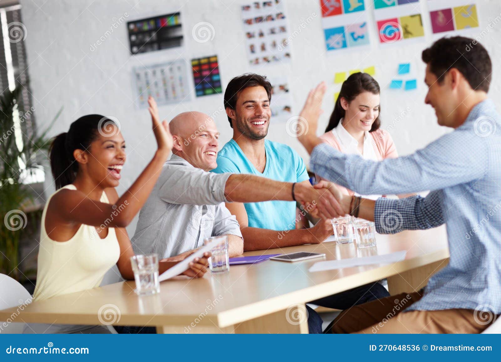 Youve Earned it. Two Men Shaking Hands while Their Colleagues Cheer ...