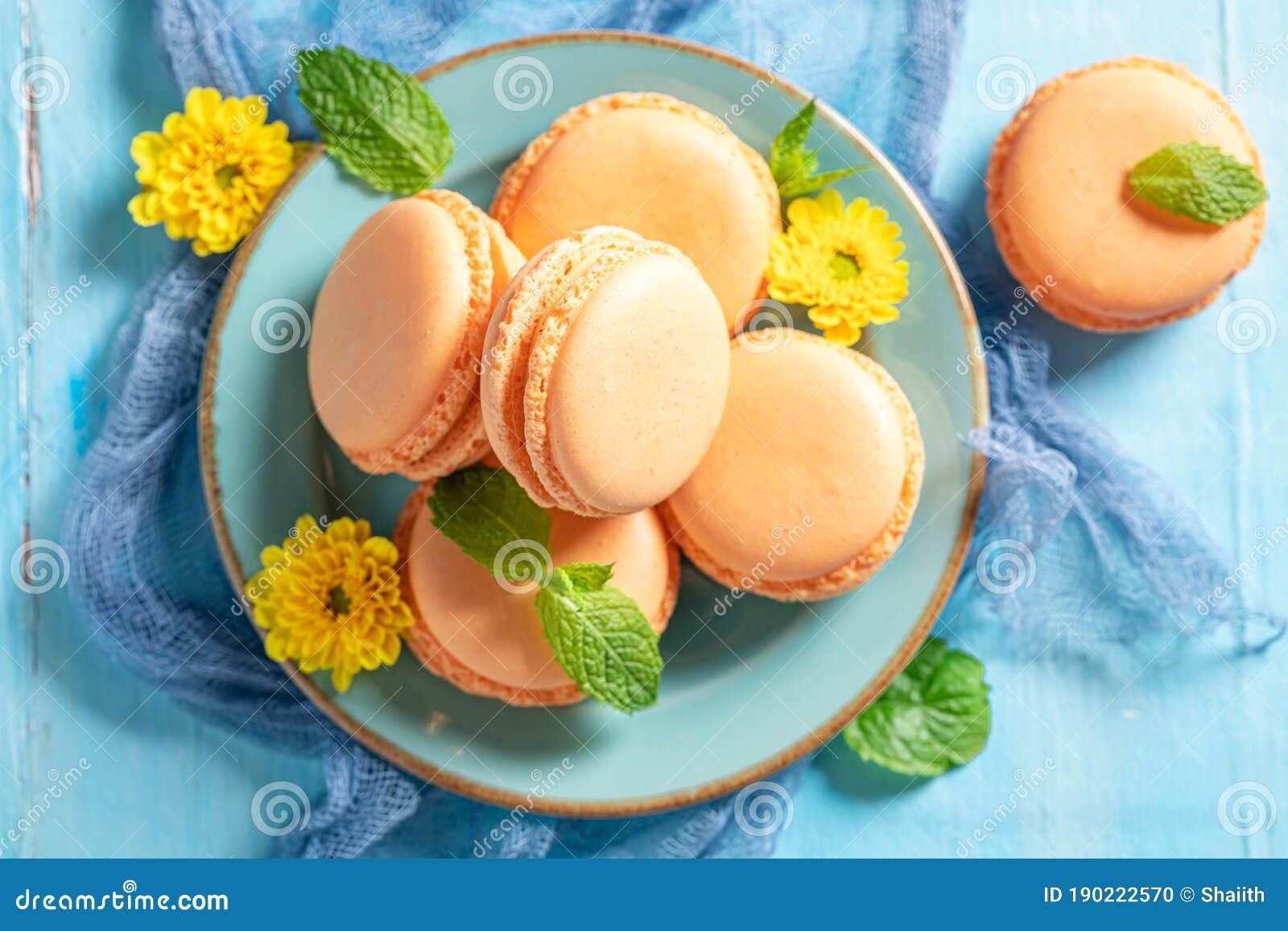 Yummy Orange Macaroons on Table and Yellow Flowers Stock Photo - Image ...