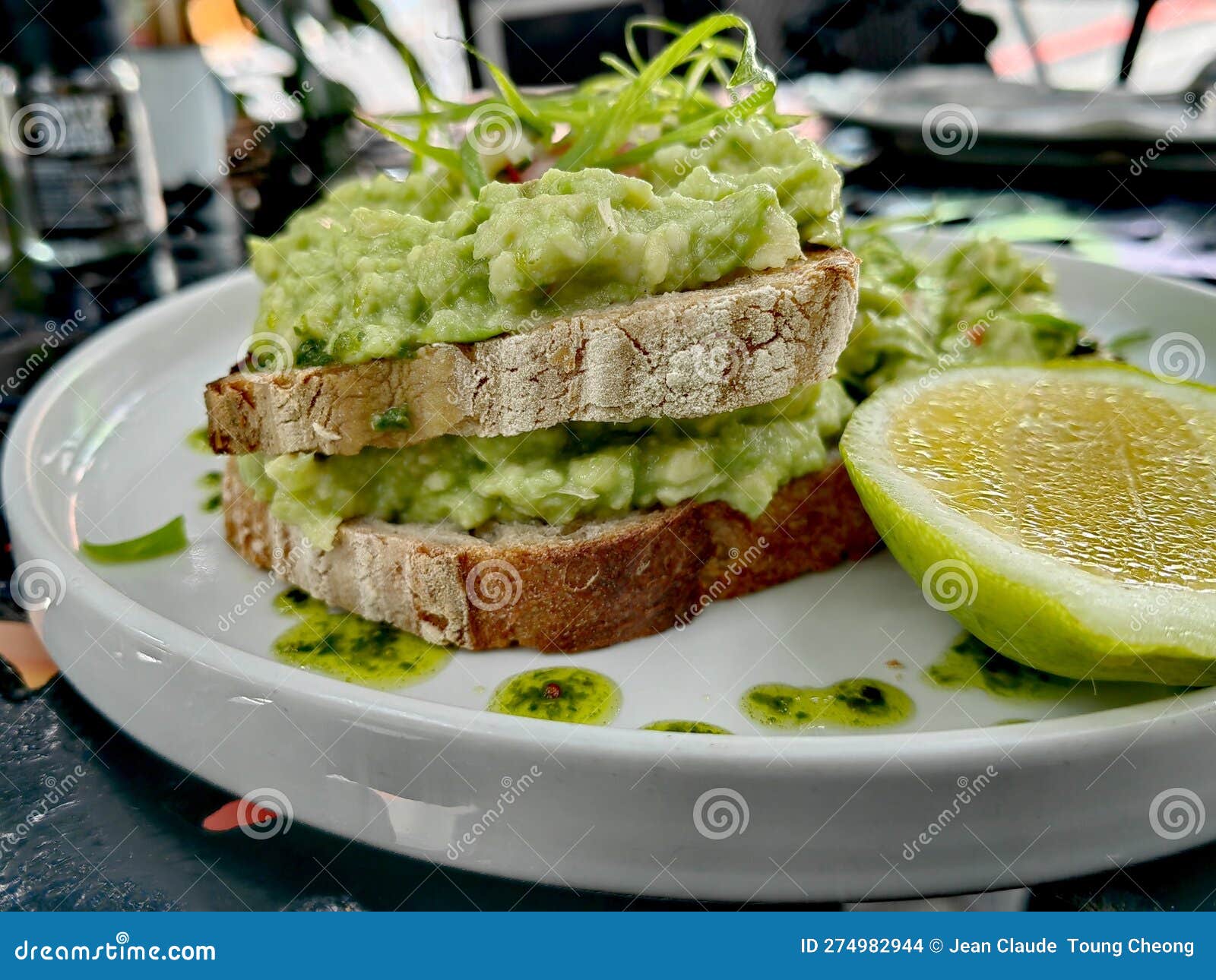 Yummy Smashed Avocado Toast with Lemon Slice on the Side! Stock Photo ...