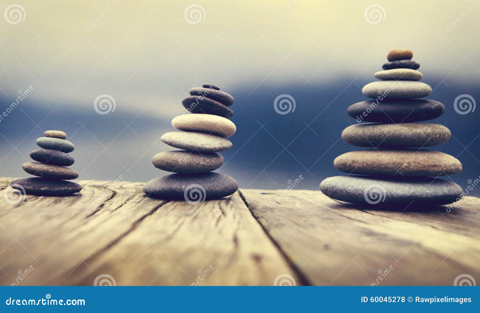 Zen Balancing Pebbles Next To a Misty Lake Concept Stock Photo - Image ...