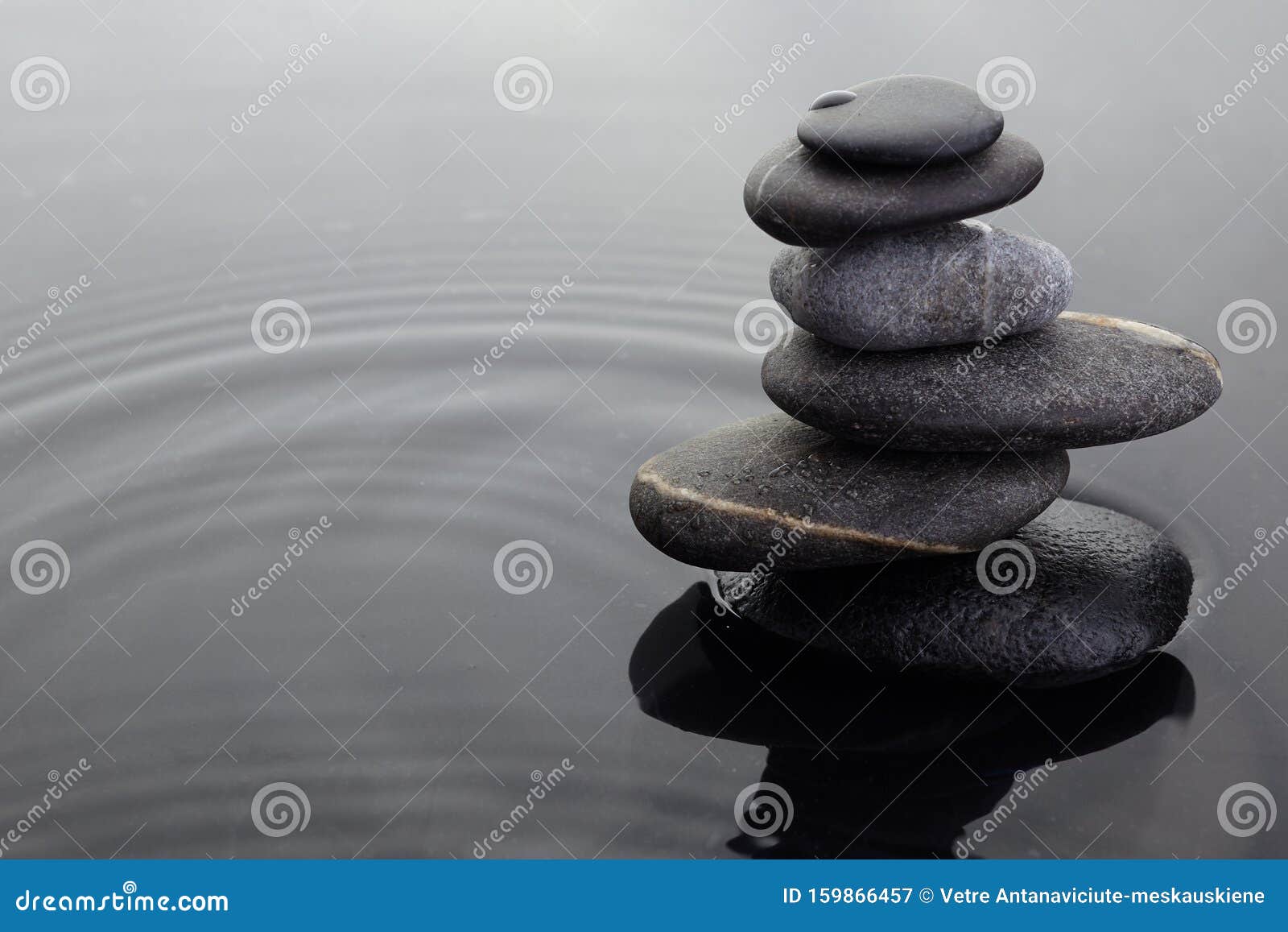 Zen Stones in Balanced Pile in Water on Rippled Water Surface. Stock ...