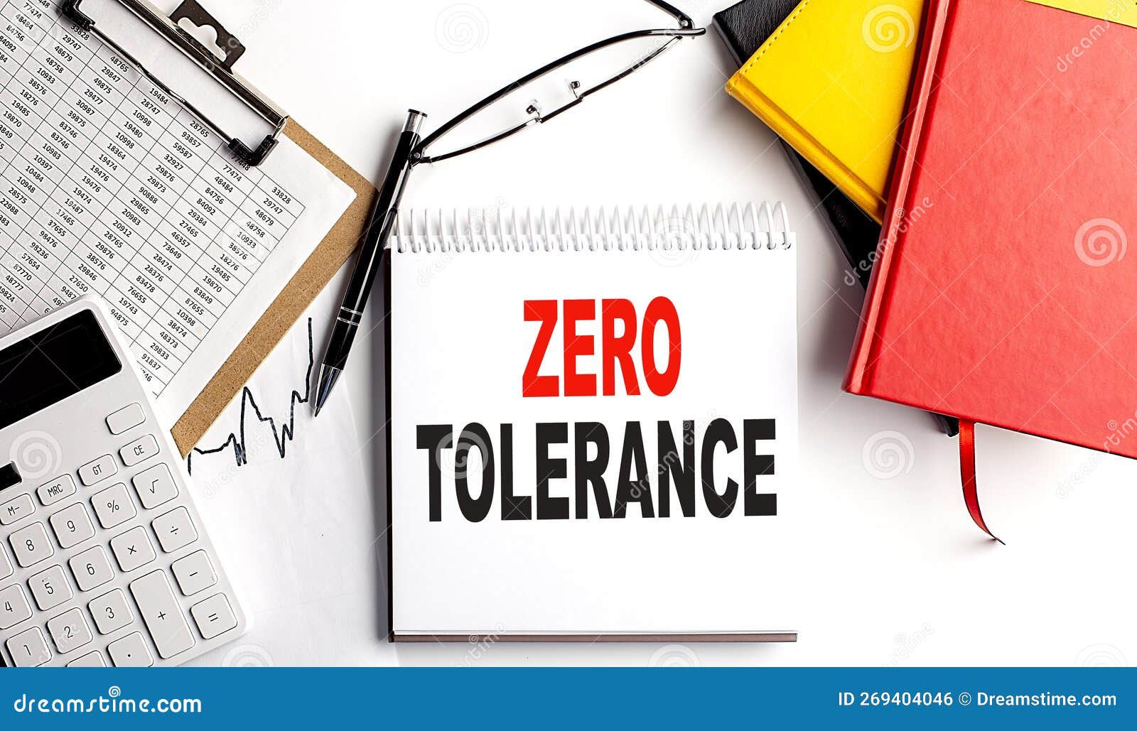 ZERO TOLERANCE Text on Notebook with Clipboard and Calculator on White ...