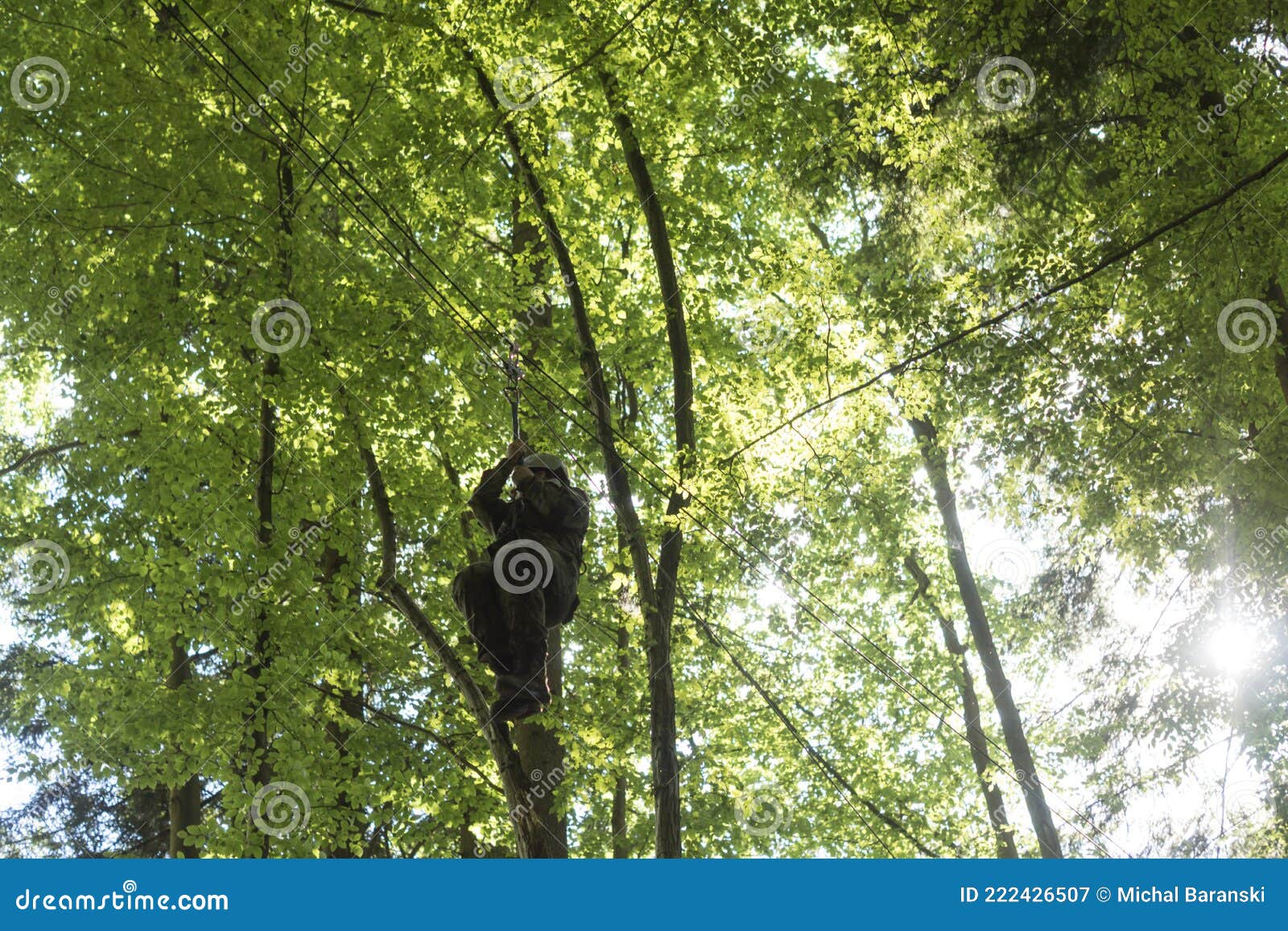Zip lining in a forest stock image. Image of cable, military - 222426507