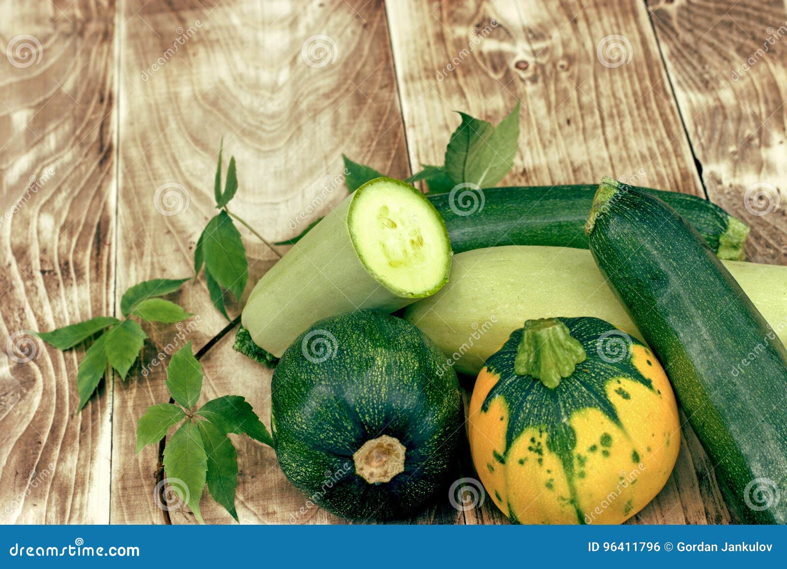 Zucchini, Marrow Squash and Pumpkin on Rustic Wooden Table Stock Photo ...
