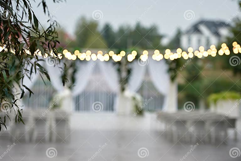 èƒŒæ™¯è“ ï¼Œæœ‰å©šæ‹±ï¼Œæ‹±é—¨ä¸¤ä¾§çš„æ¤…å ï¼Œæˆ·å¤ å©šç¤¼çš„ç ¯æ³¡ç